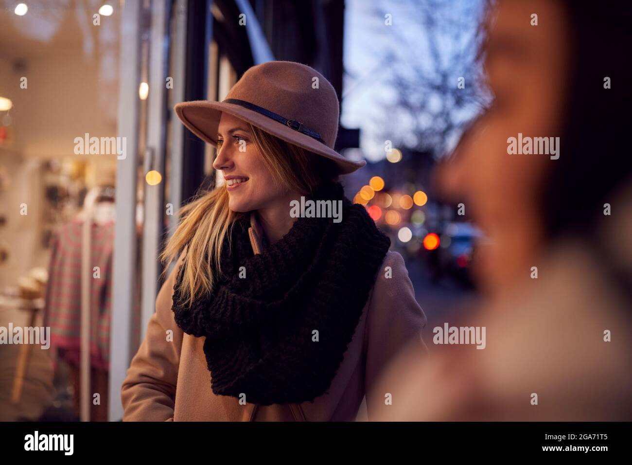 Back of person looking in shop window hi-res stock photography and ...