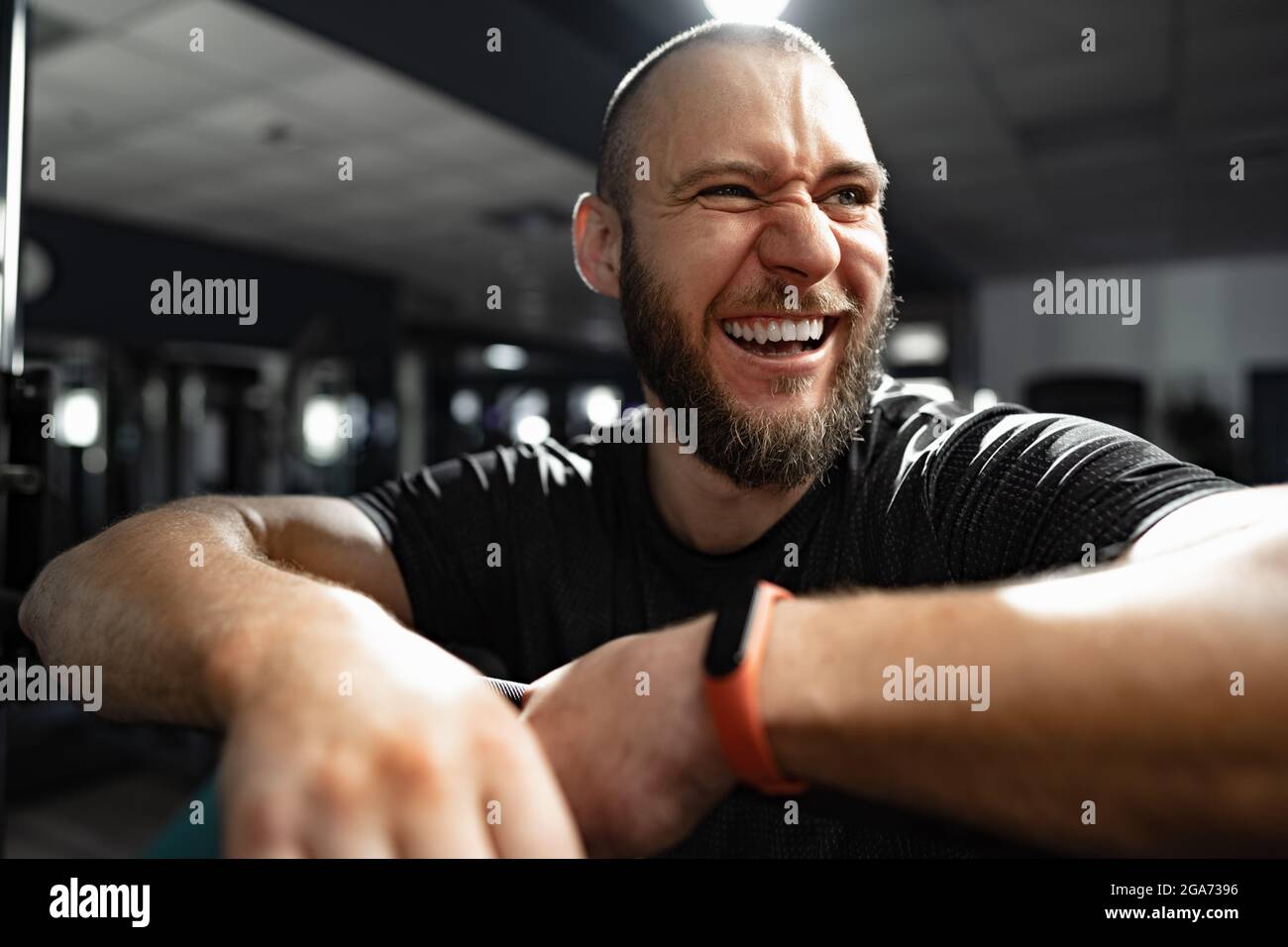 Cheerful smiling man bodybuilder standing in a gym Stock Photo - Alamy