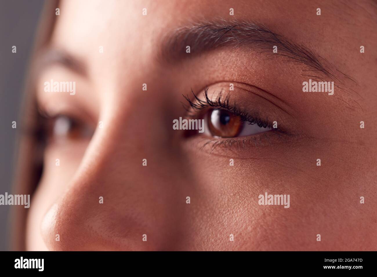 Close Up On Eyes Of Smiling Young Woman Shot Full Frame In Studio Stock ...