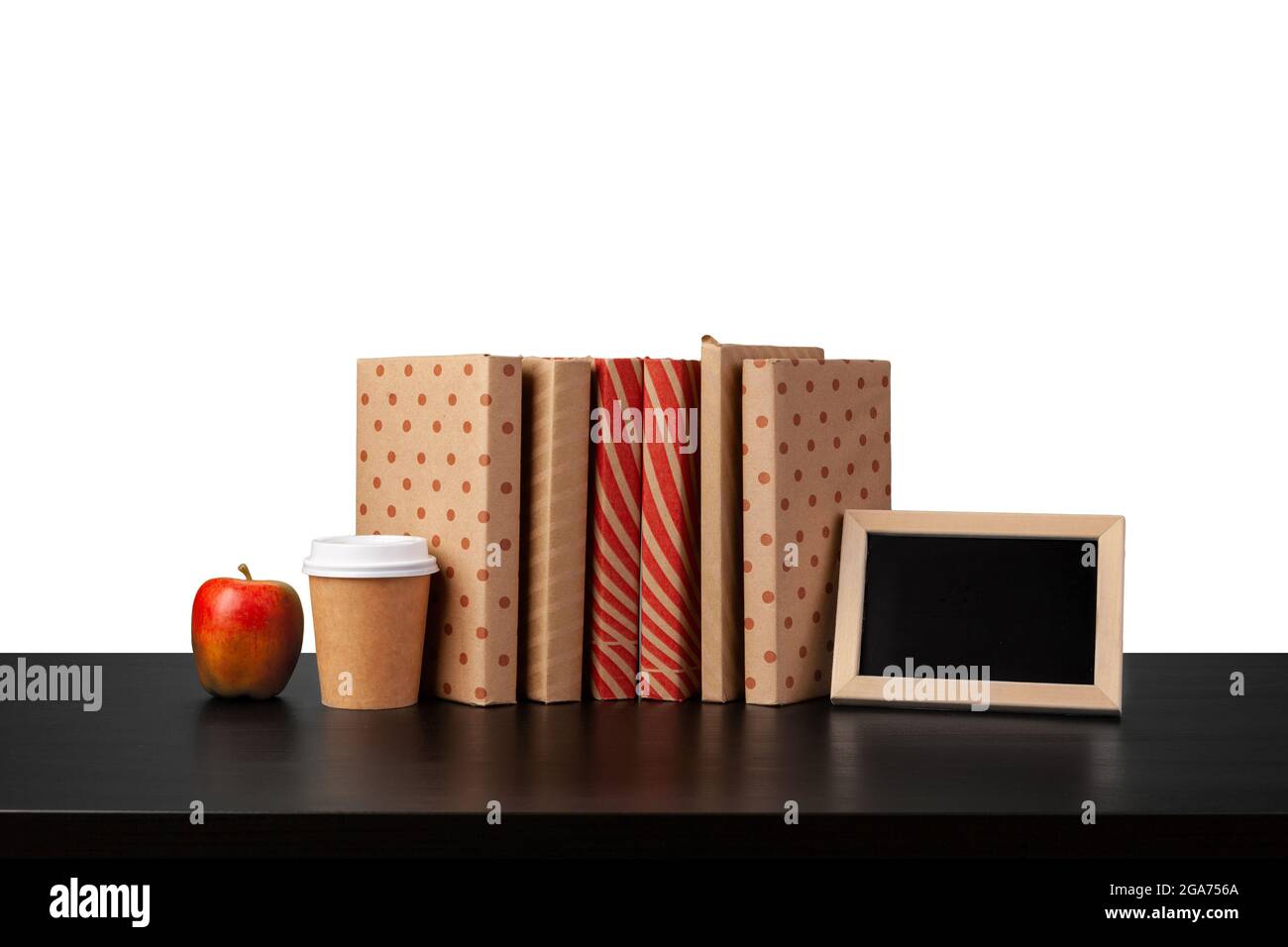 Stack of books and apple on tabletop against white background Stock ...