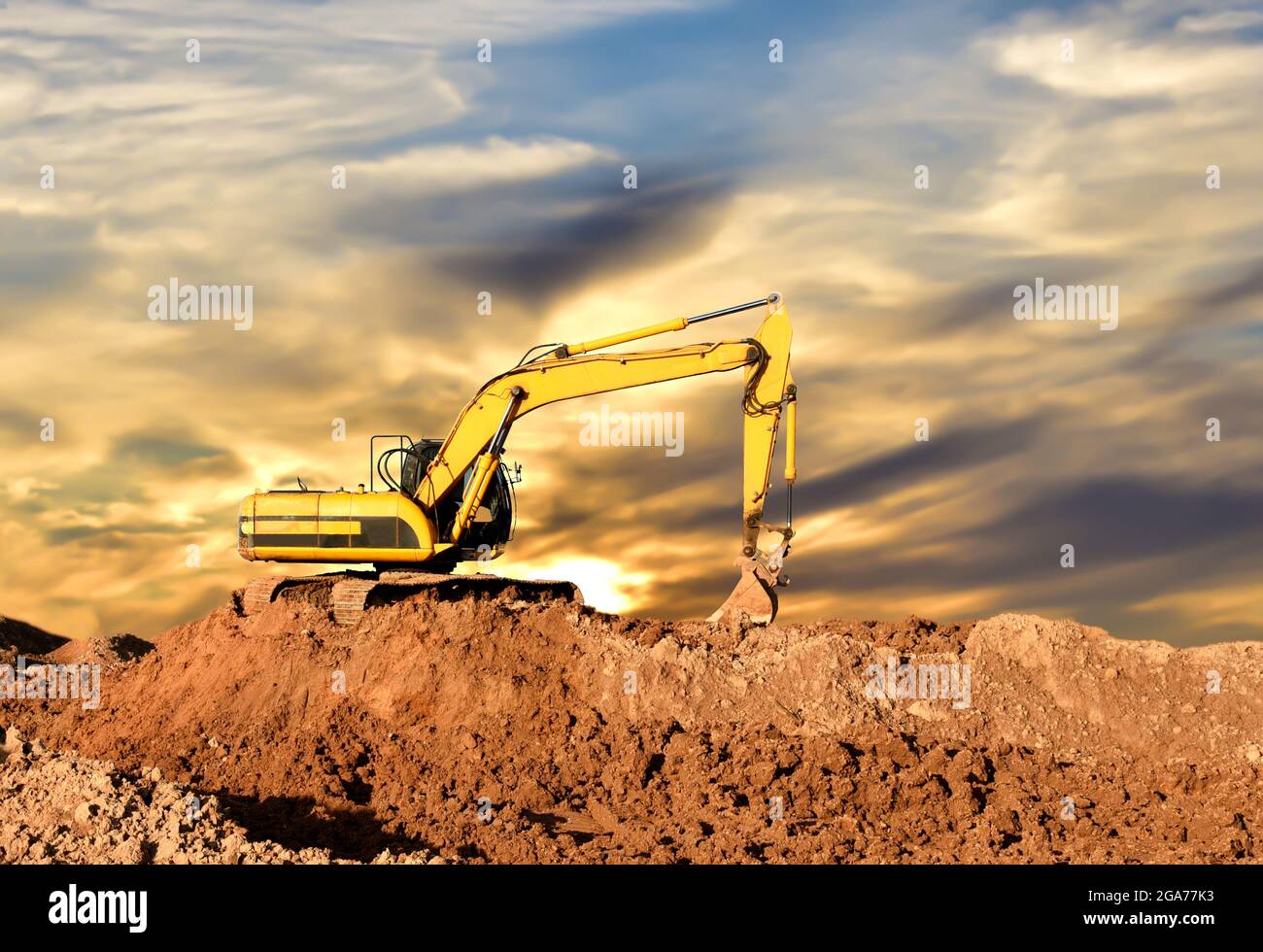 Excavator working on earthmoving at open pit mining on amazing sunset ...