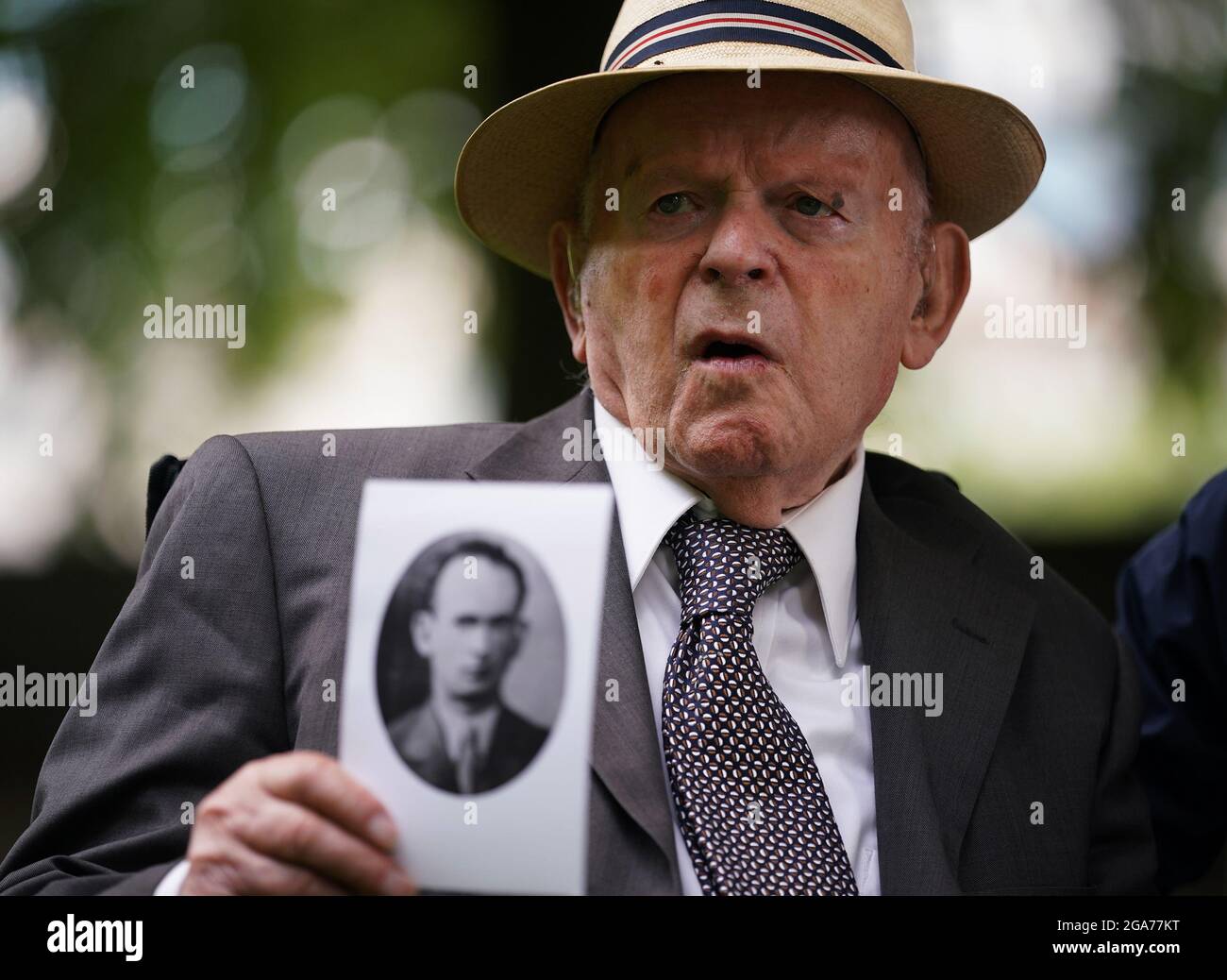 Holocaust survivor Sir Ben Helfgott holding a photograph of his father ...