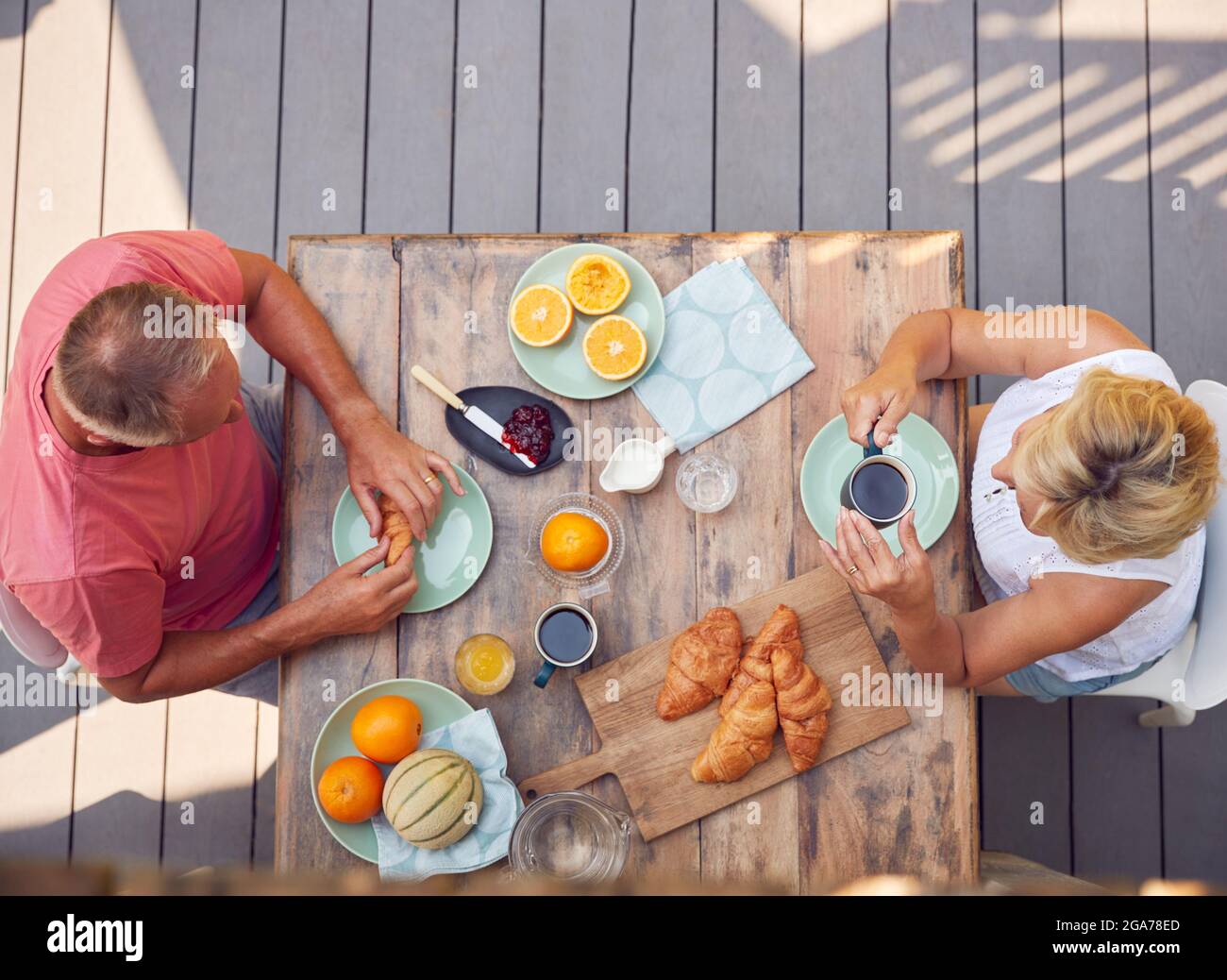 Overhead Shot Of Retired Couple Outdoors On Deck At Home Eating ...