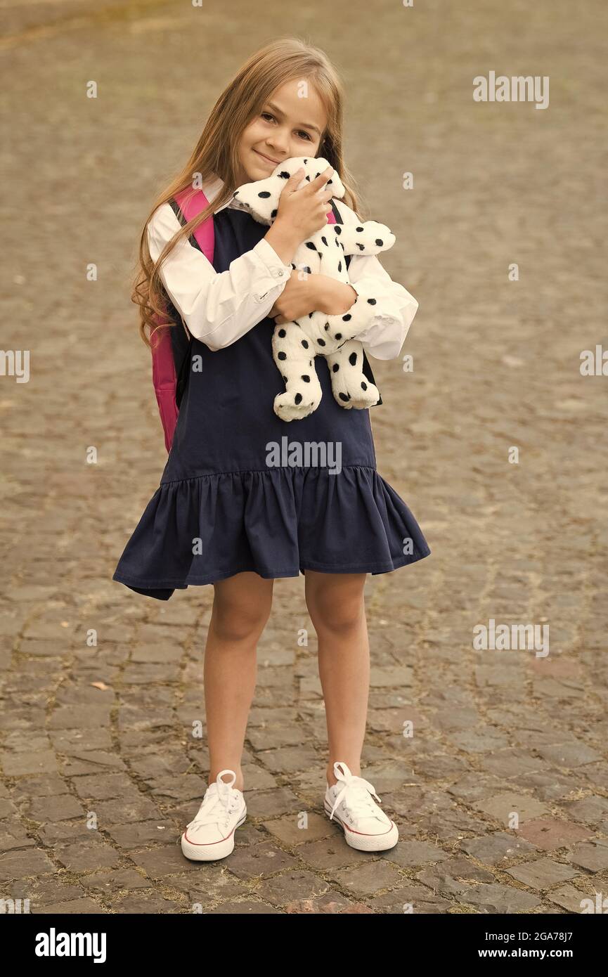 Make time for play. Happy kid hug toy outdoors. Toy friend. Educational ...