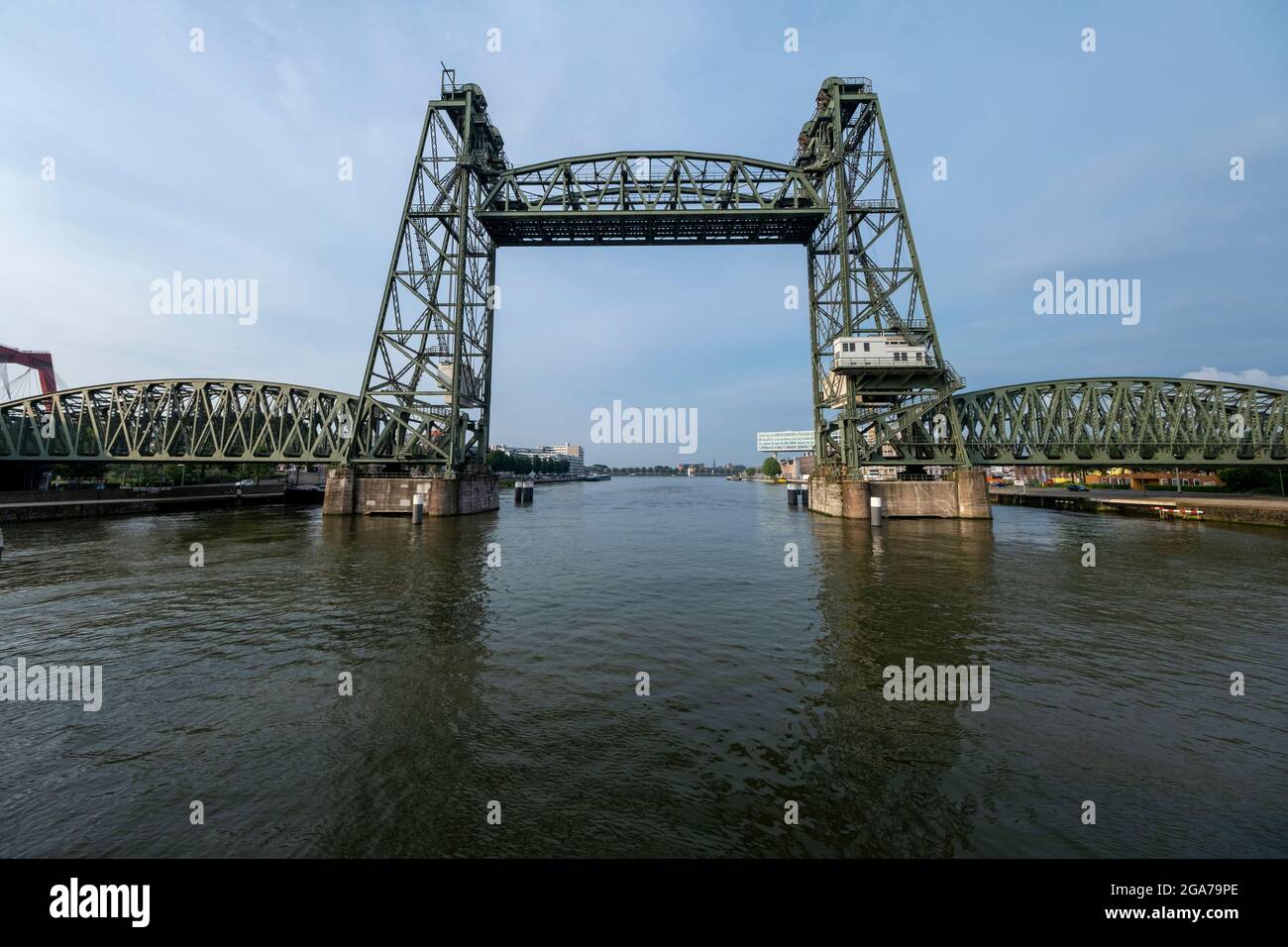 Opened olive green, steel elevator bridge over a canal on a beautiful ...