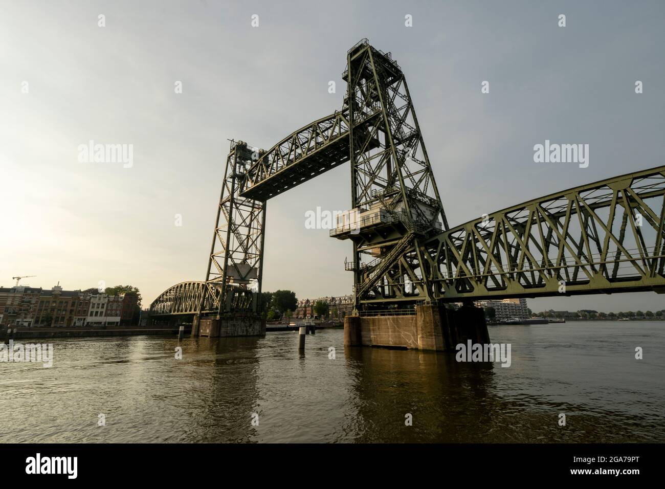Opened olive green, steel elevator bridge over a canal on a beautiful ...