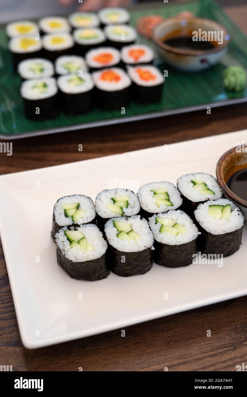 A table with two plates of vegetarian sushi, side view, vertical Stock ...