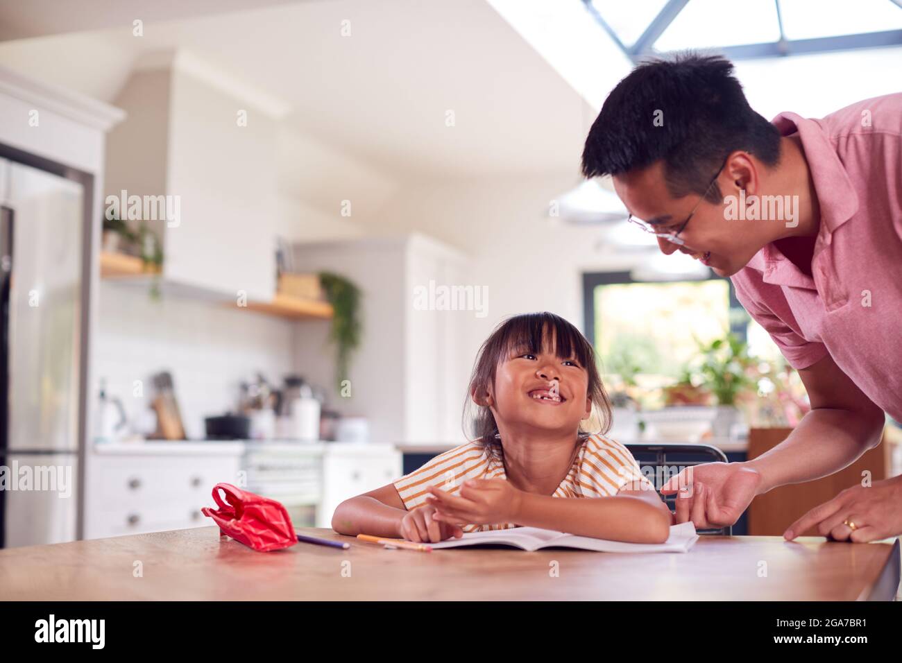 Girl sitting kitchen table writing hi-res stock photography and images ...