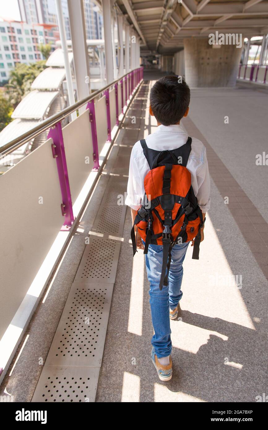School boy walking alone hi-res stock photography and images - Alamy