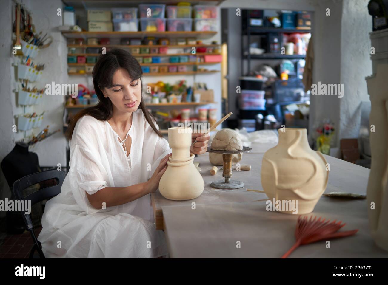 Delicate work during a pottery class Stock Photo - Alamy