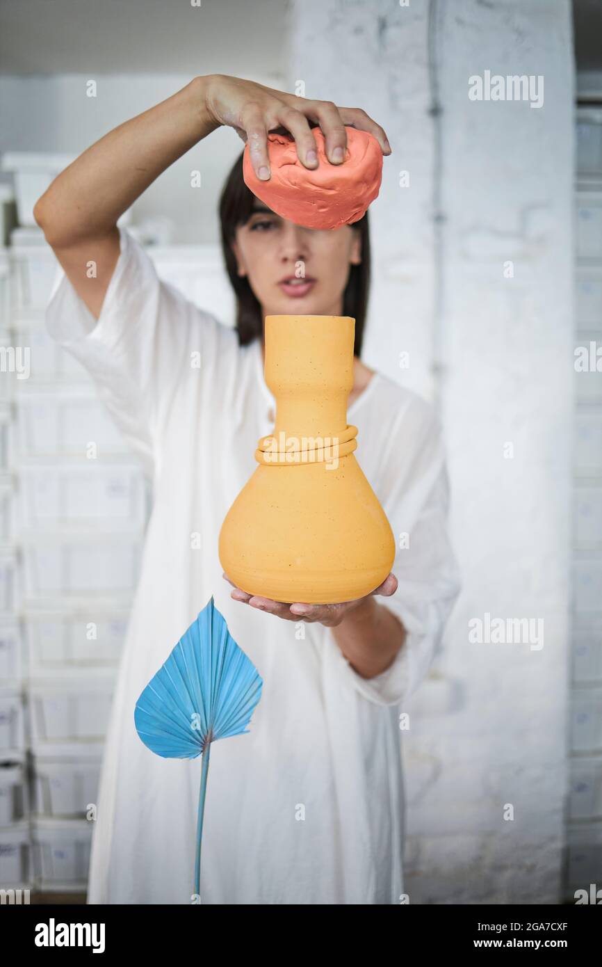 An artist holding her colorful artwork Stock Photo - Alamy