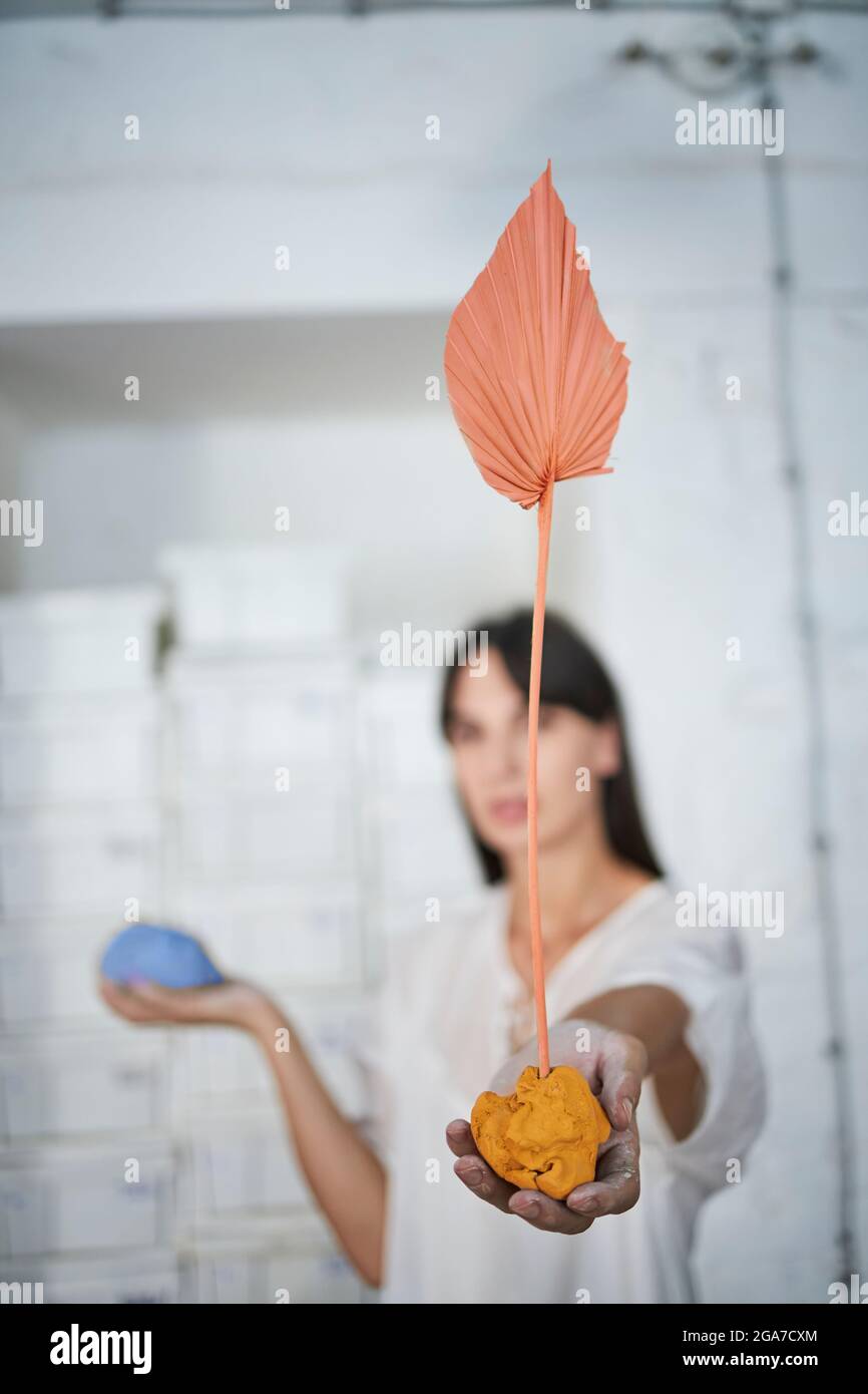 Female artist holding colorful clay in her hands Stock Photo - Alamy