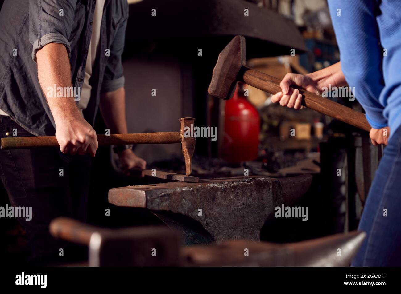 Close up male female blacksmiths hi-res stock photography and images ...