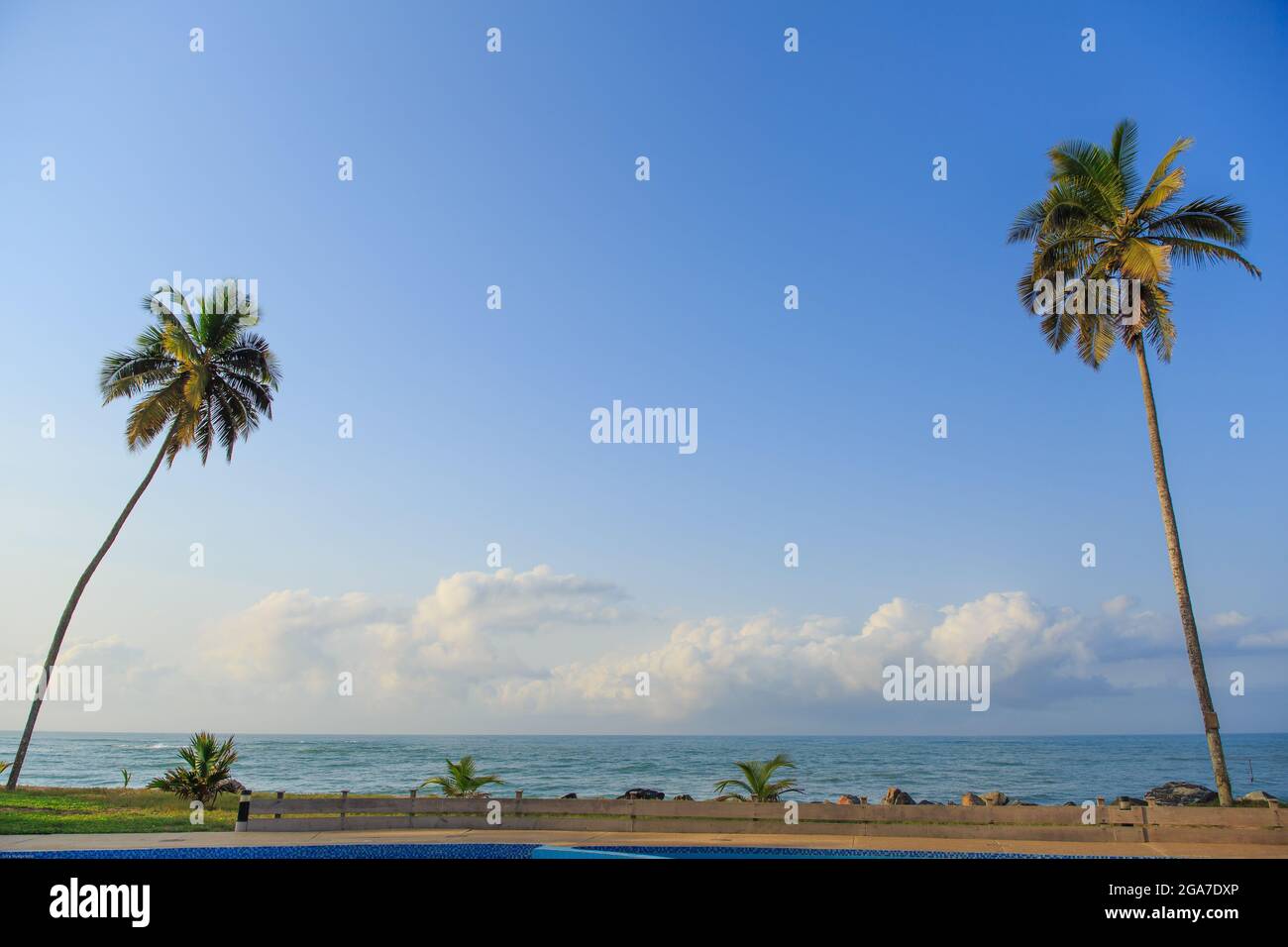 Pool beside sea and coconut palm tree with blue sky in Cape Cost, Ghana ...