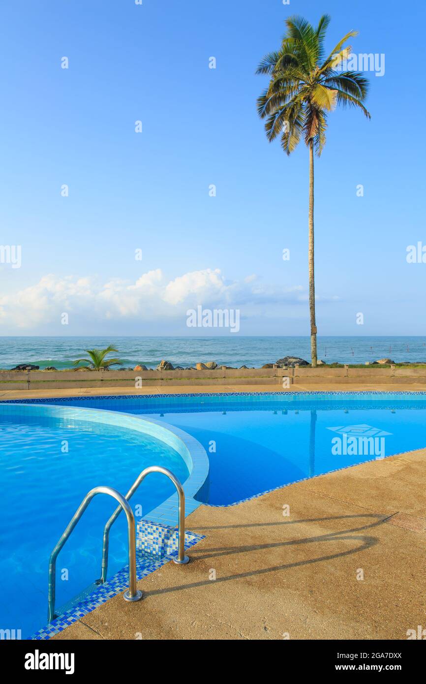 Pool beside sea and coconut palm tree with blue sky in Cape Cost, Ghana ...