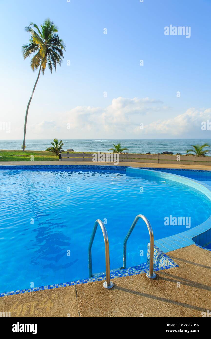 Pool beside sea and coconut palm tree with blue sky in Cape Cost, Ghana ...