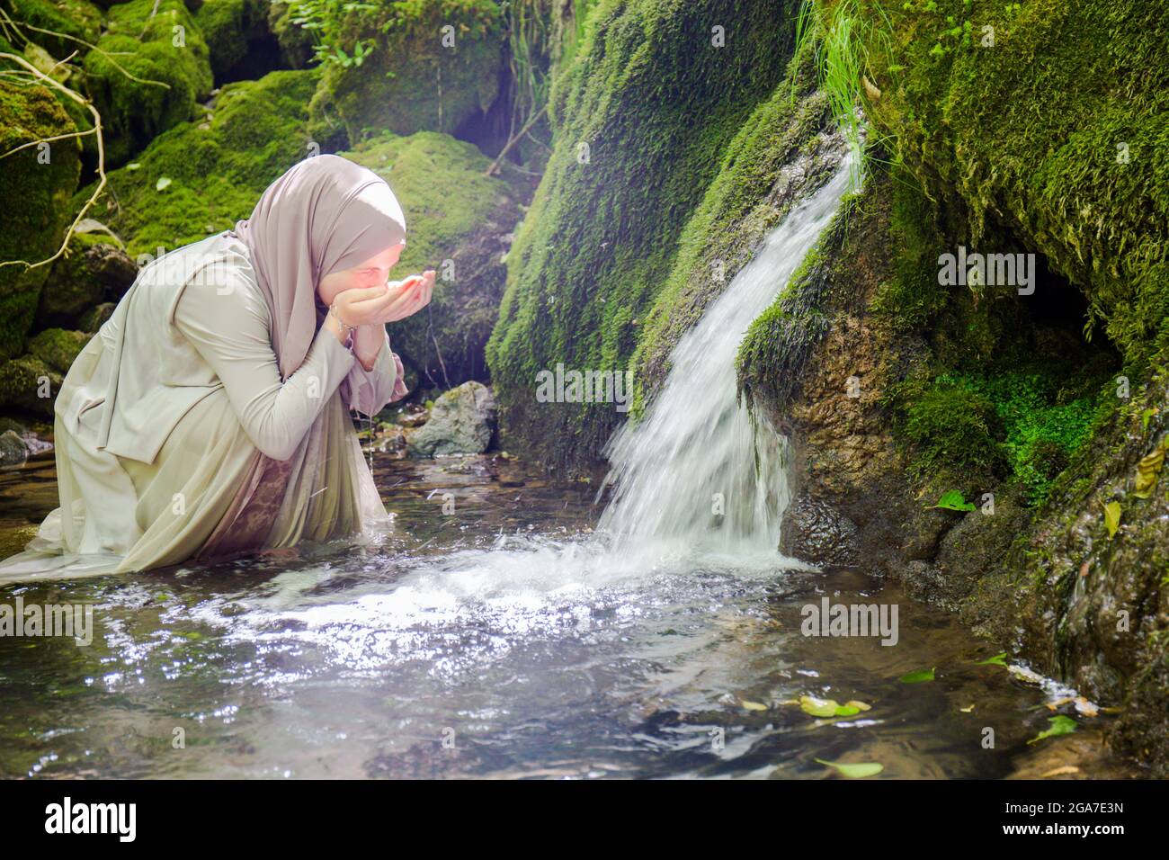 A young Muslim woman with hijab untouched nature, enjoys the natural ...