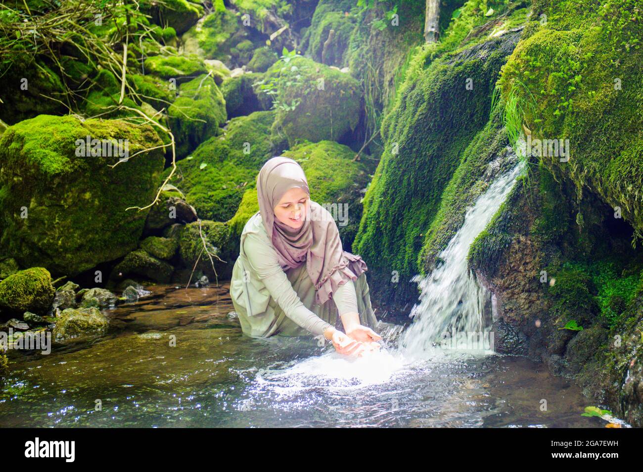 A young Muslim woman with hijab untouched nature, enjoys the natural ...