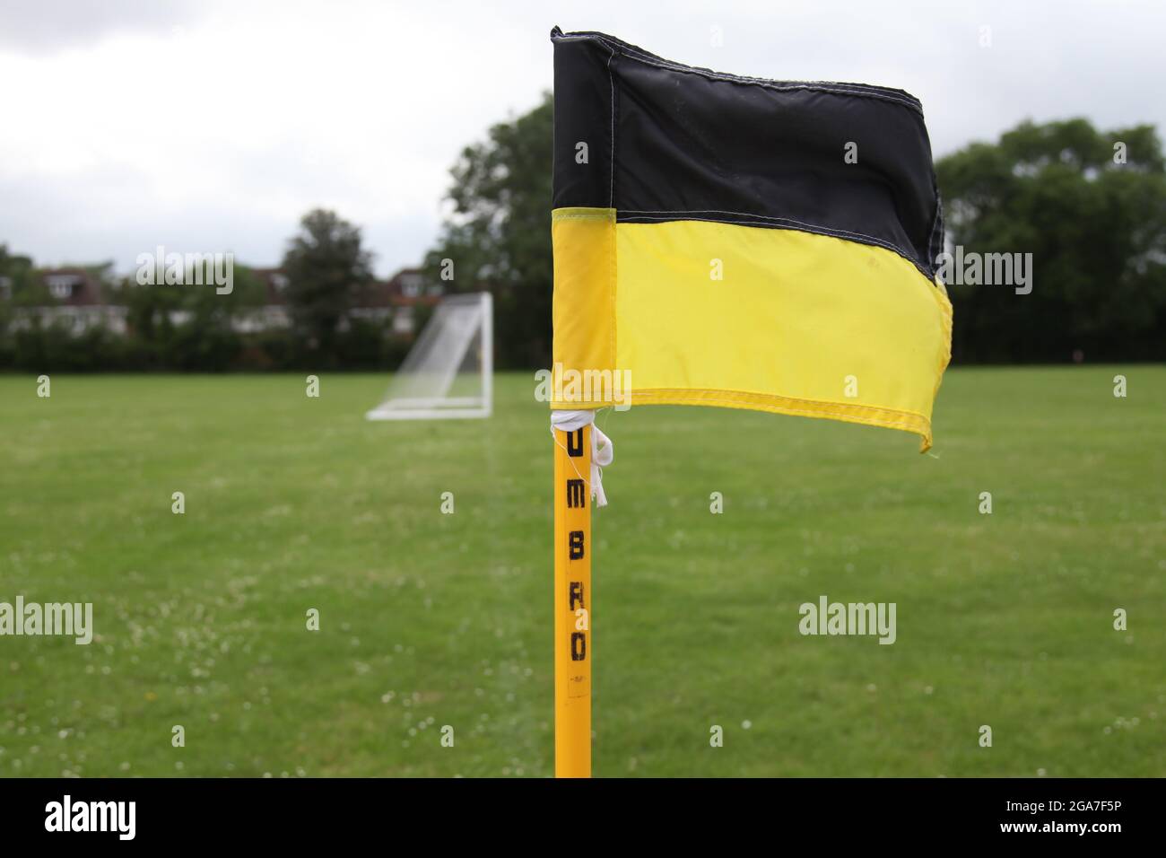 Close up Umbro football corner post flag pole on footie pitch, black ...