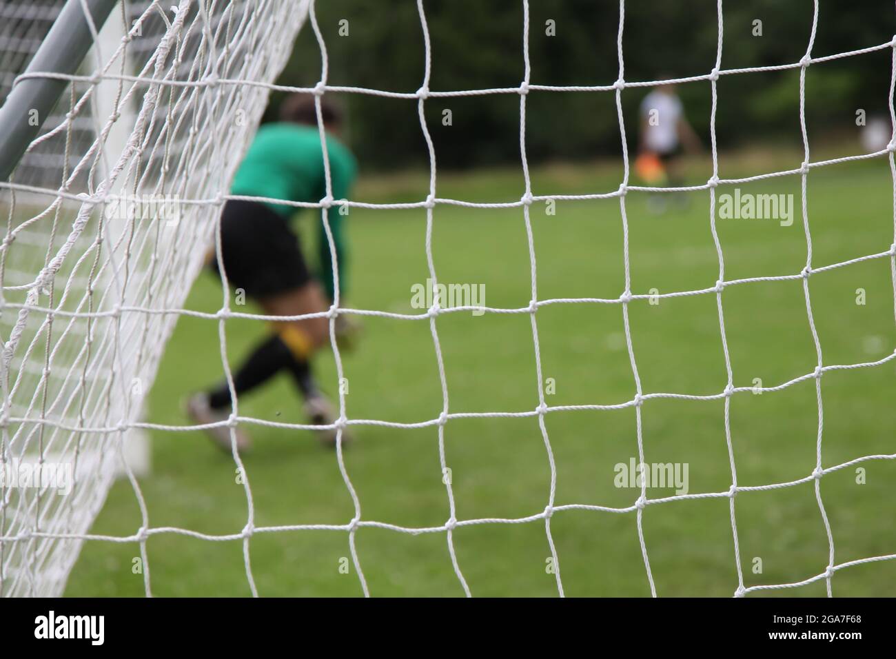 Football pitch seen through nets hi-res stock photography and images ...