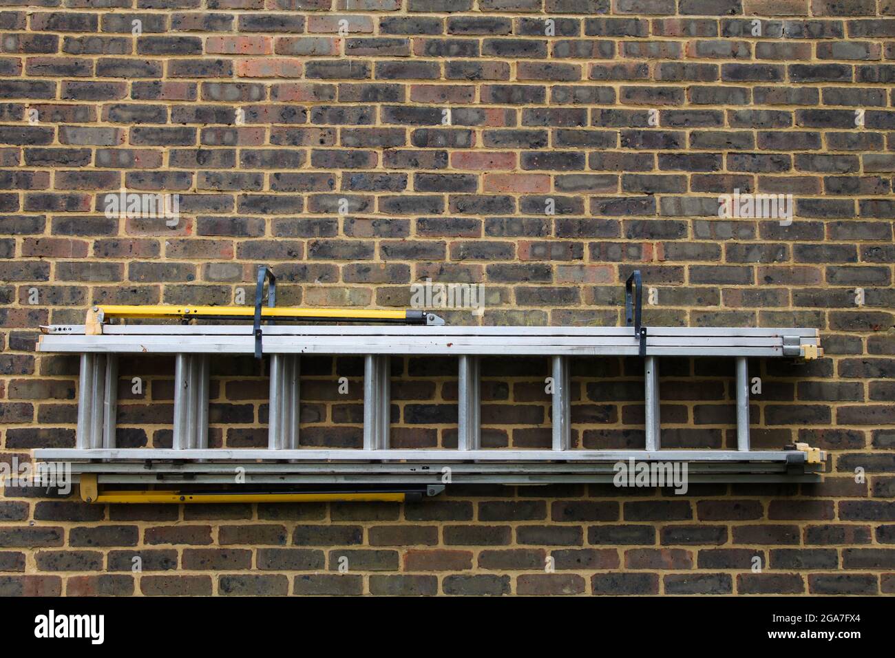 Three piece ladder secured to house wall with brackets to avoid theft ...