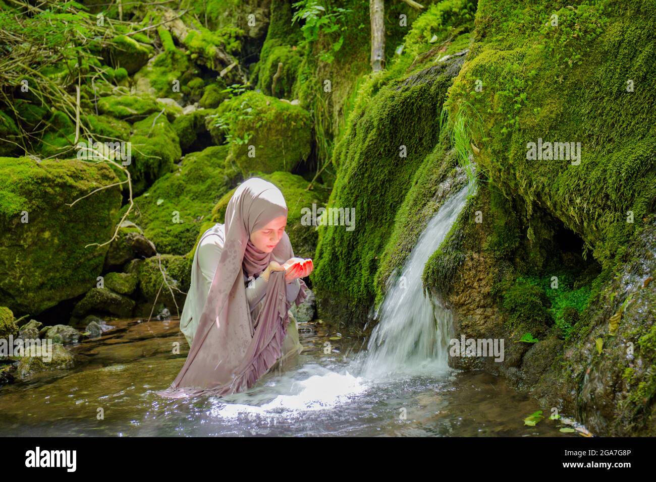 A young Muslim woman with hijab untouched nature, enjoys the natural ...