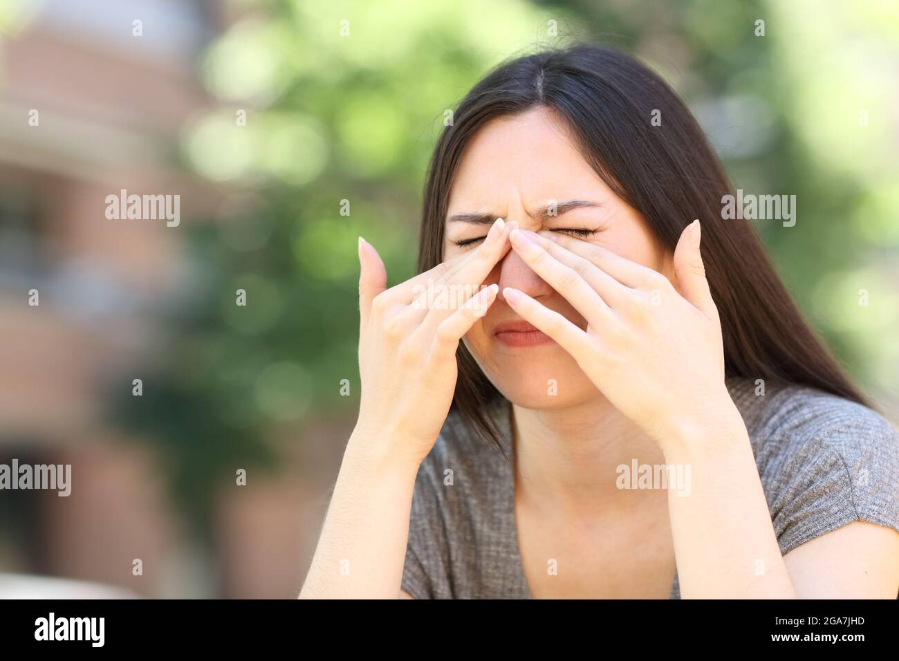 Stressed asian woman scratching itchy eyes in the street Stock Photo ...