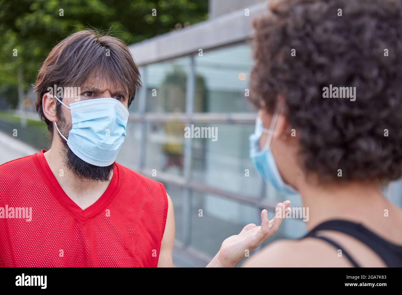 Two people having a conversation protected by face masks Stock Photo ...