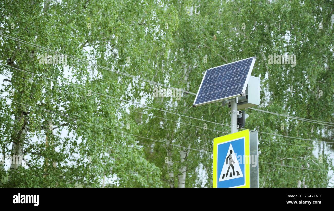 Solar panels and road sign with built-in flashing yellow traffic light ...