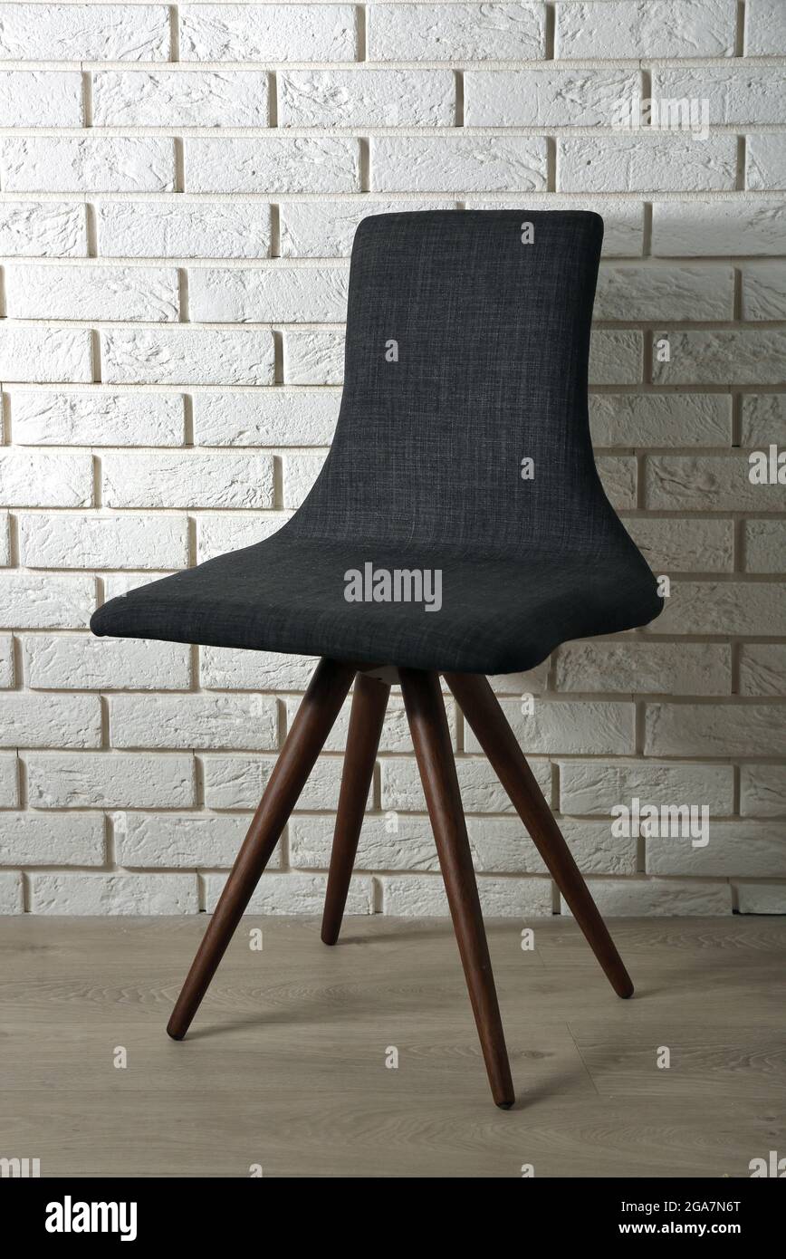 Modern chair on brick wall background Stock Photo - Alamy