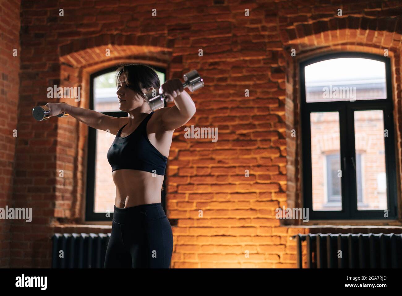 Shoot from below of young athletic woman with beautiful strong body ...