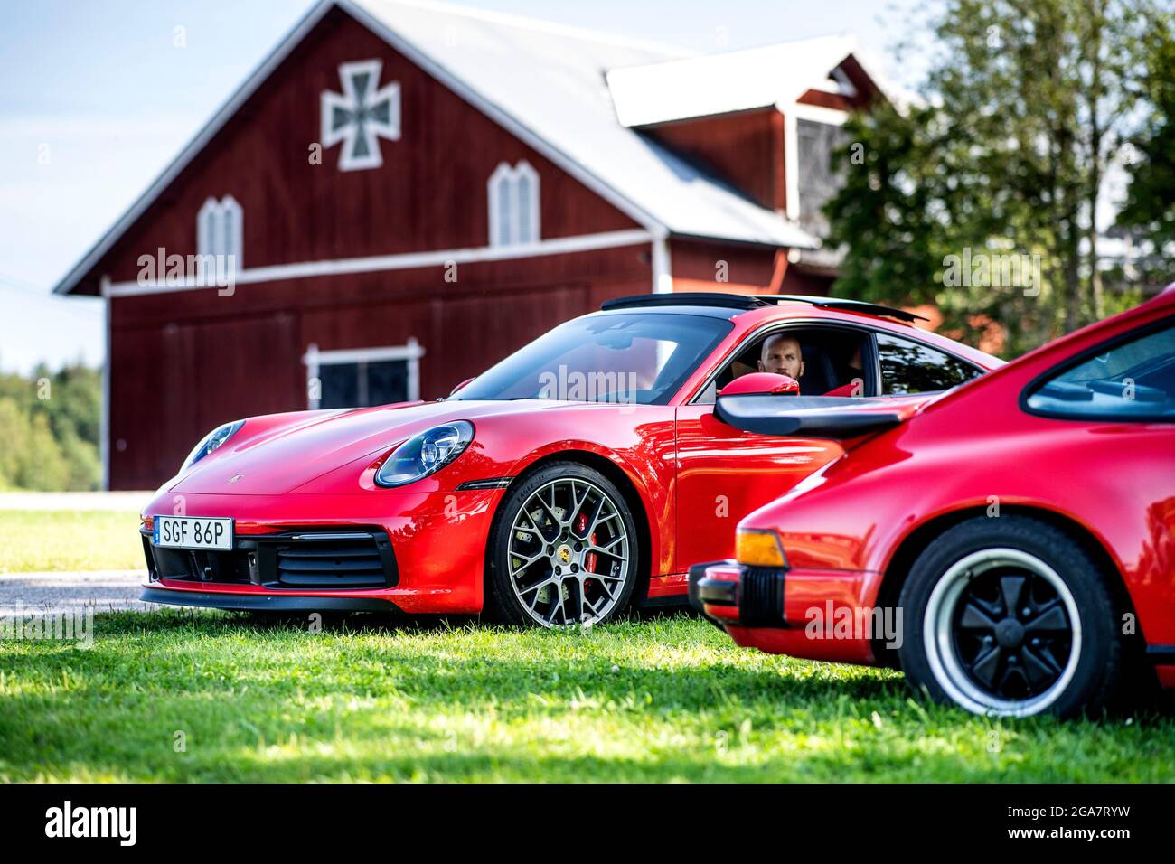 A red Porsche 911 Carrera 4S 2019/2020 (left) and a 911 Carrera from ...
