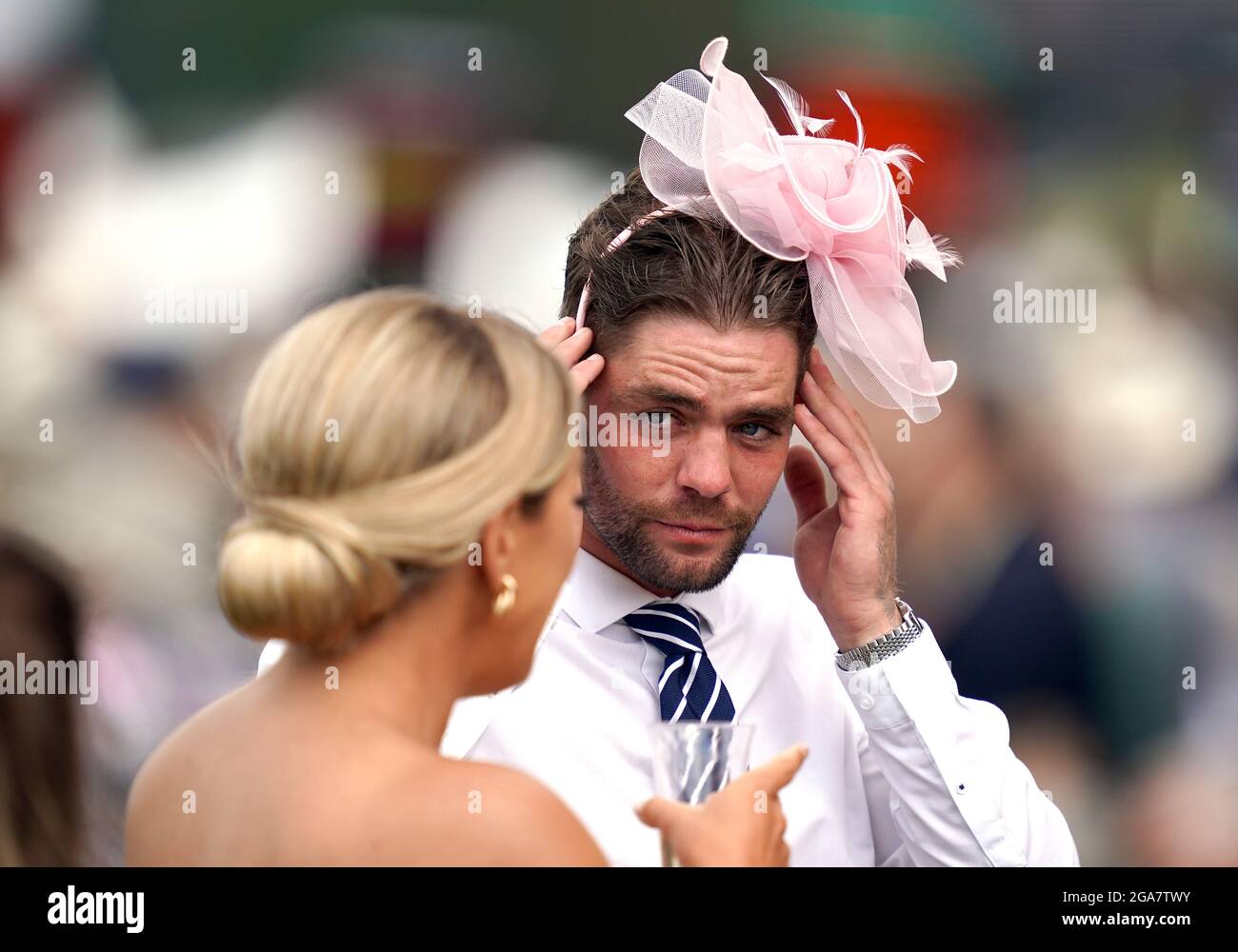 Racegoers swap headgear during day three of the Goodwood Festival at ...