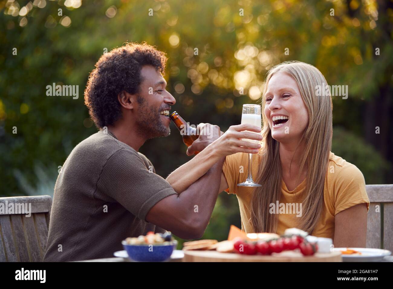 Romantic couple drinking beer arms hi-res stock photography and images ...