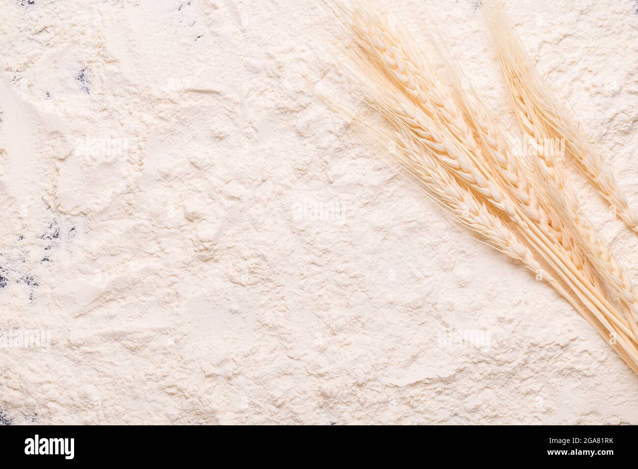 Baking or cooking background, flour on the dark background. Top view ...