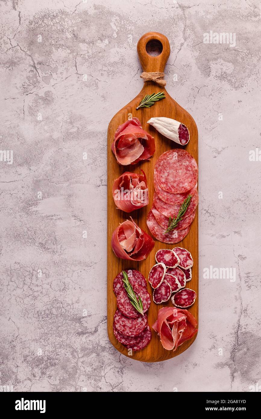 Serving board with a set of different meat snacks, top view Stock Photo ...