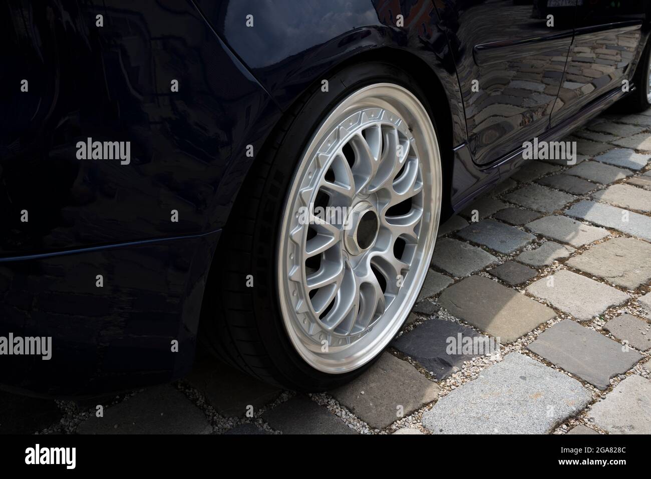 Modern car wheel with a light alloy disc. Low chassis Stock Photo - Alamy