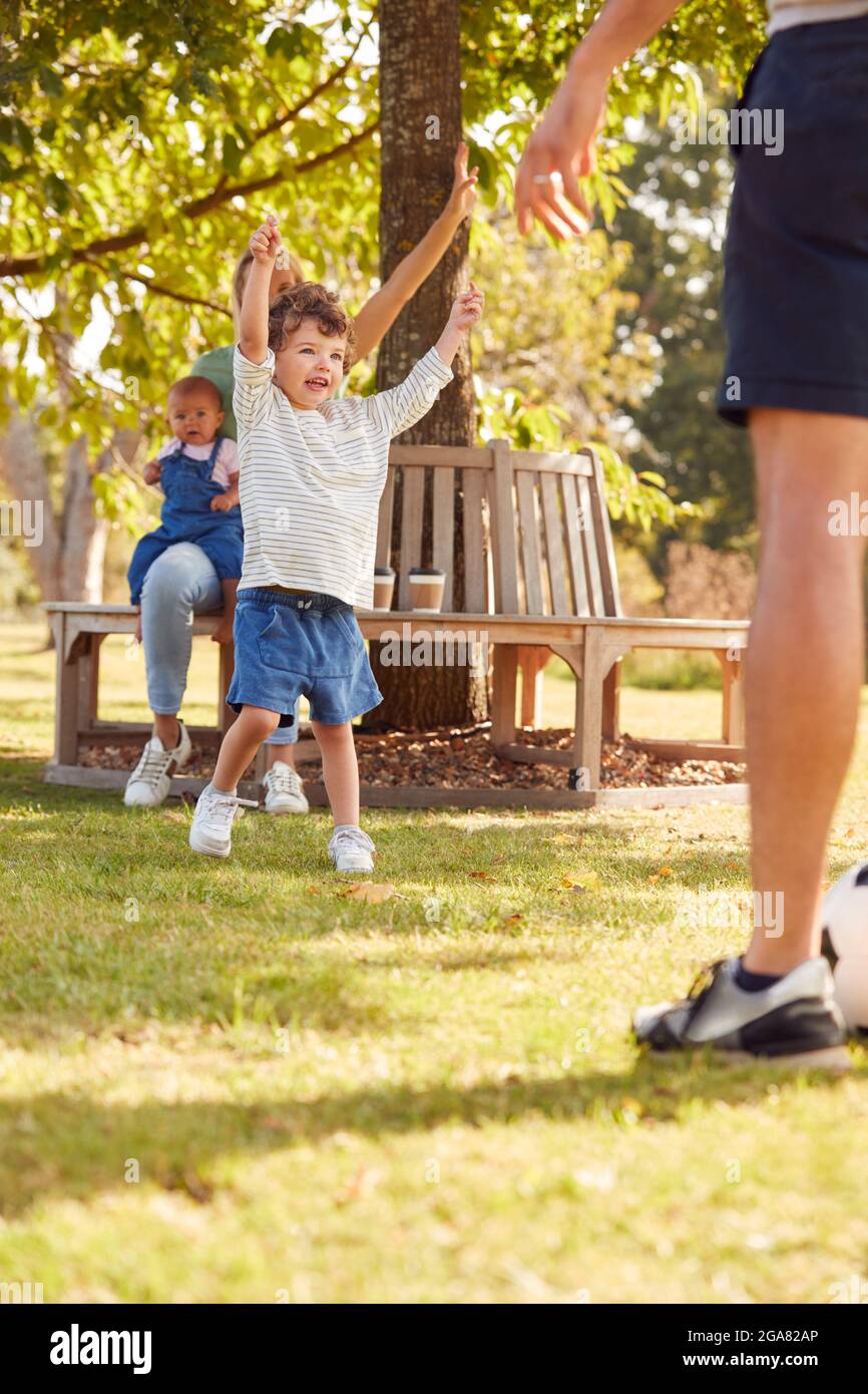 Children playing under tree in park hi-res stock photography and images ...