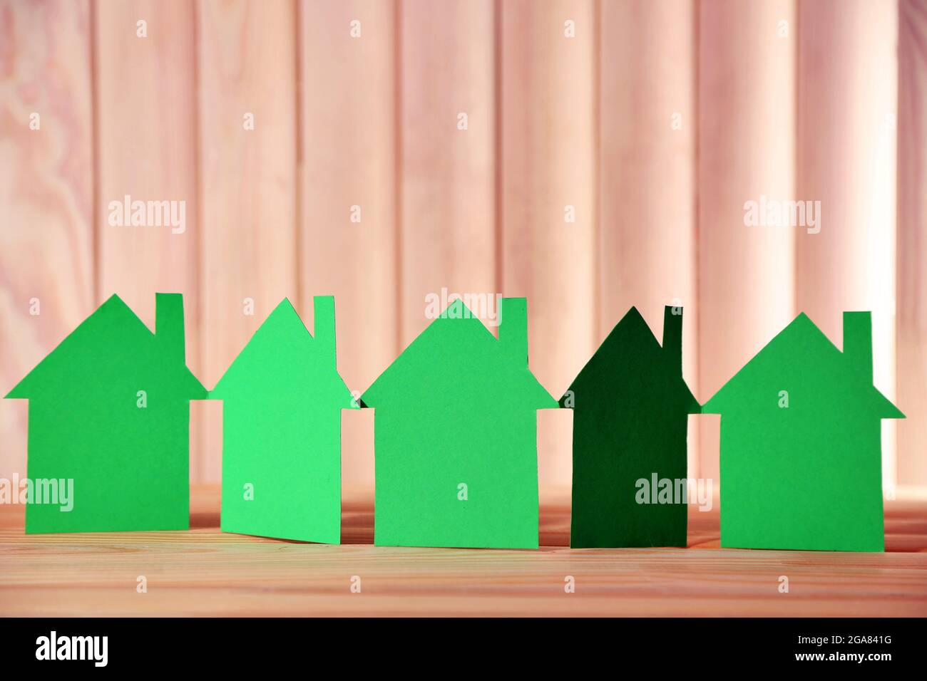 Paper houses on wooden background Stock Photo - Alamy