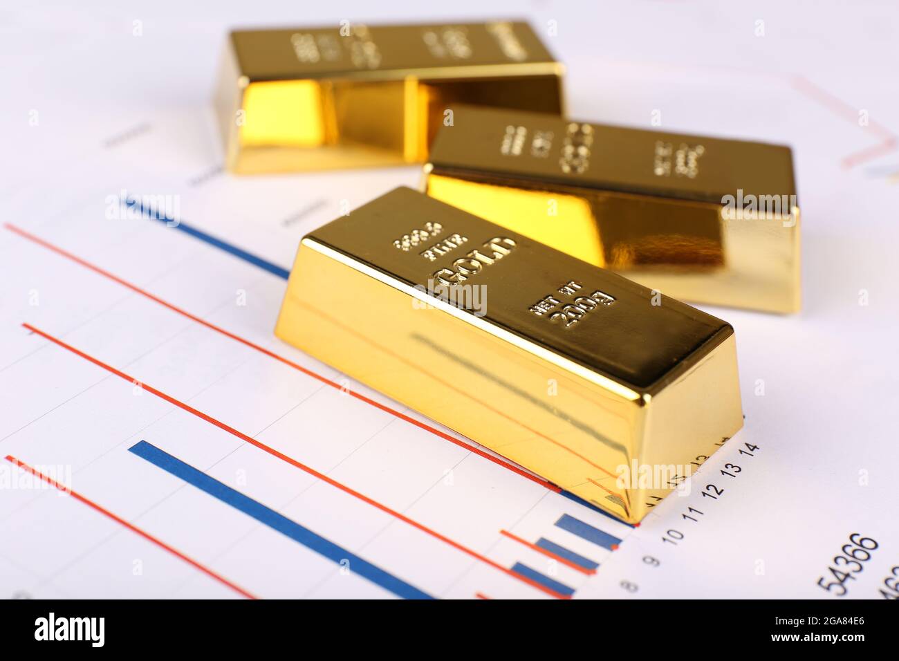 Gold bullion on documents background Stock Photo - Alamy