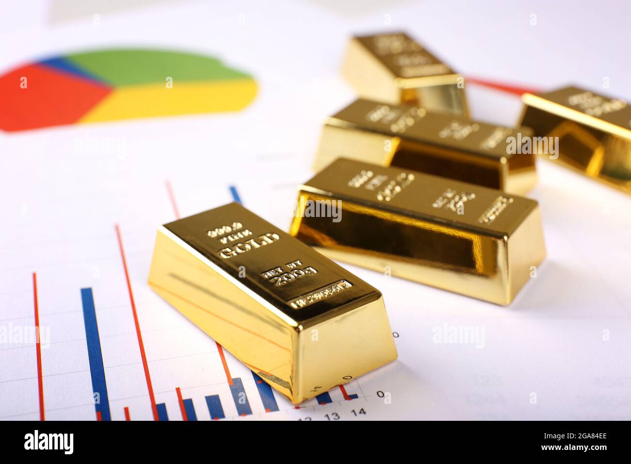 Gold bullion on documents background Stock Photo - Alamy