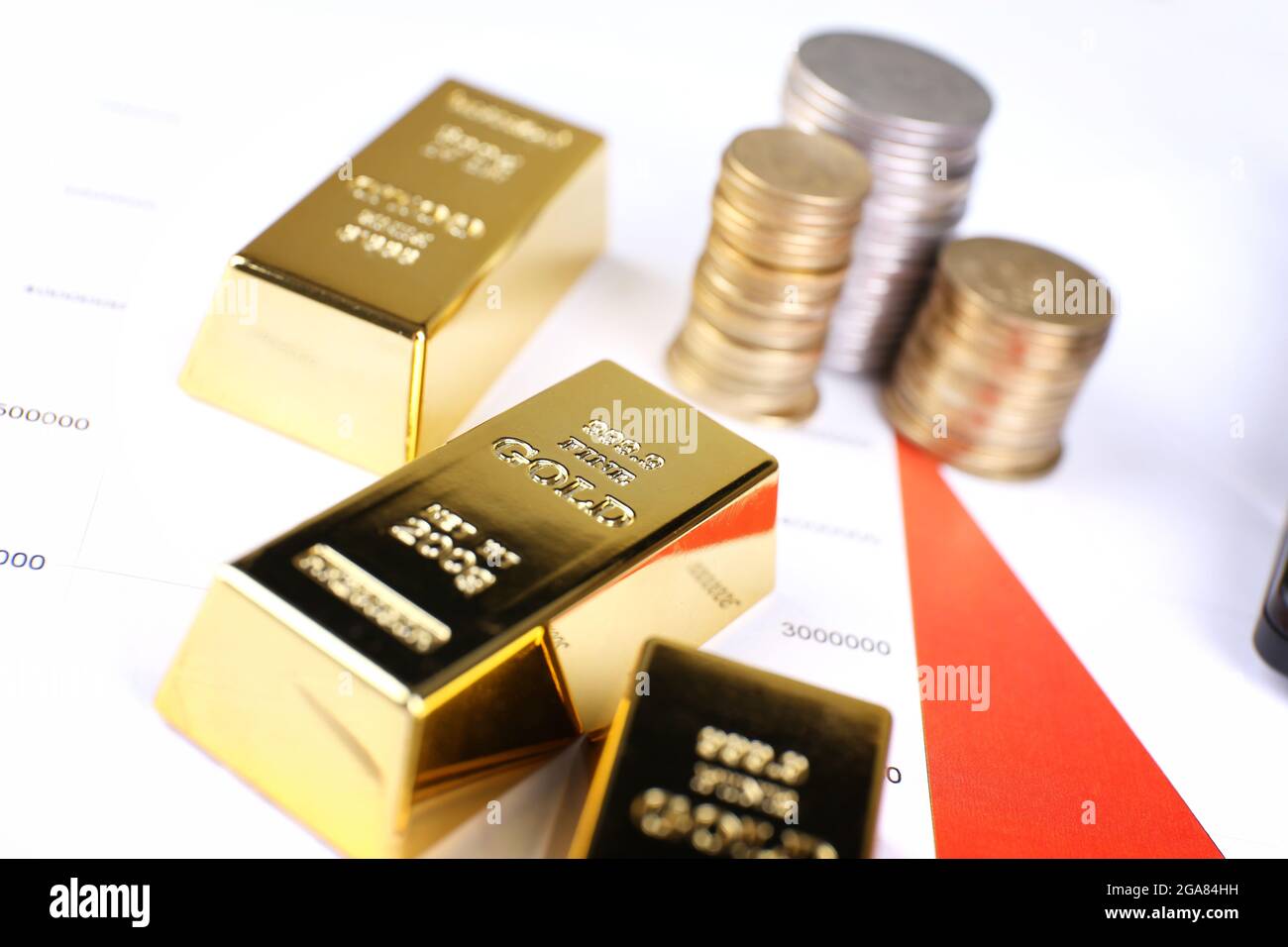 Gold bullion with coins on documents background Stock Photo - Alamy