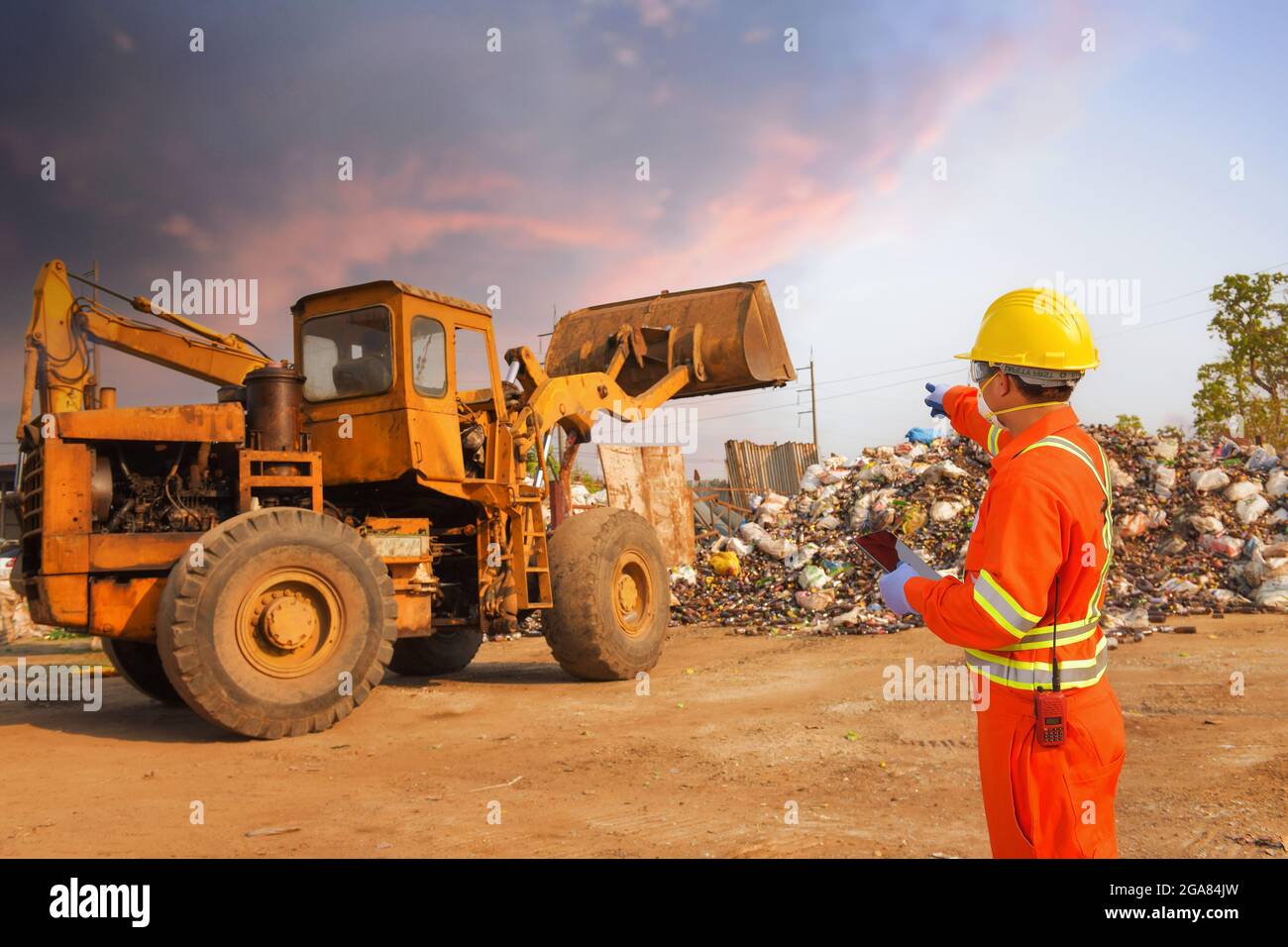 Portrait workers wearing biohazard suits and hardhats working at waste ...