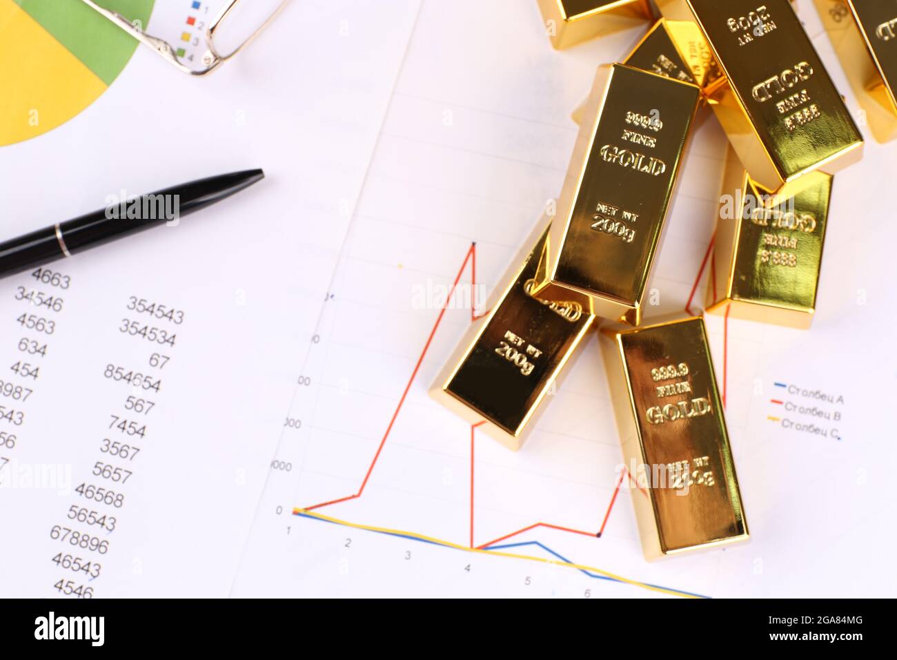 Gold bullion on documents background Stock Photo - Alamy