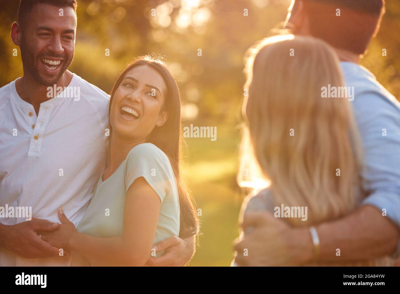 Group Of Friends On Walk In Countryside Against Flaring Sun Stock Photo ...