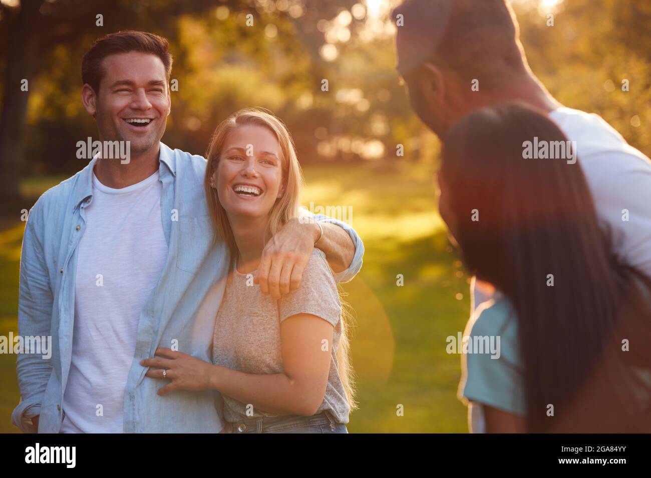 Group Of Friends On Walk In Countryside Against Flaring Sun Stock Photo ...