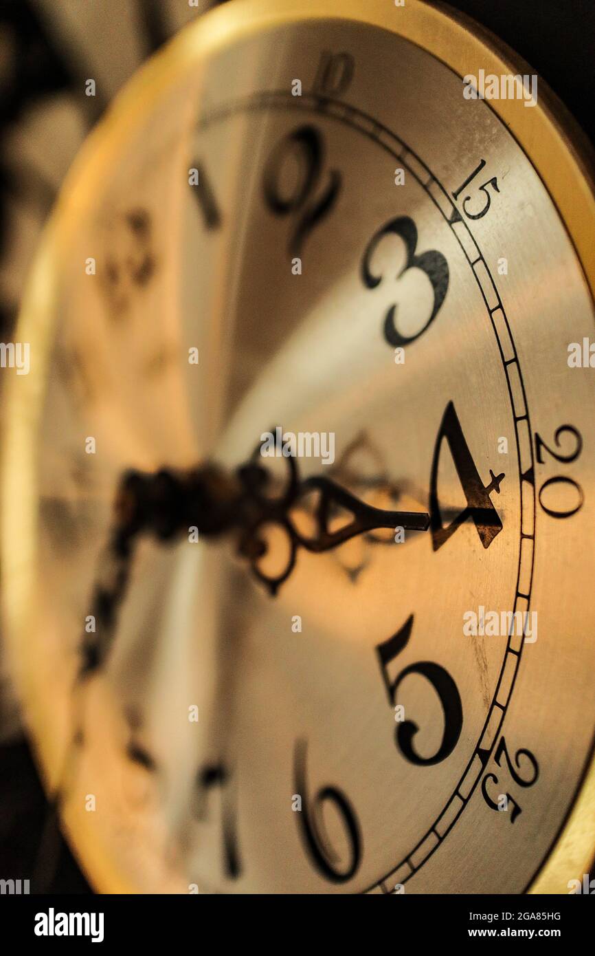 Vertical closeup of a golden clock face Stock Photo - Alamy