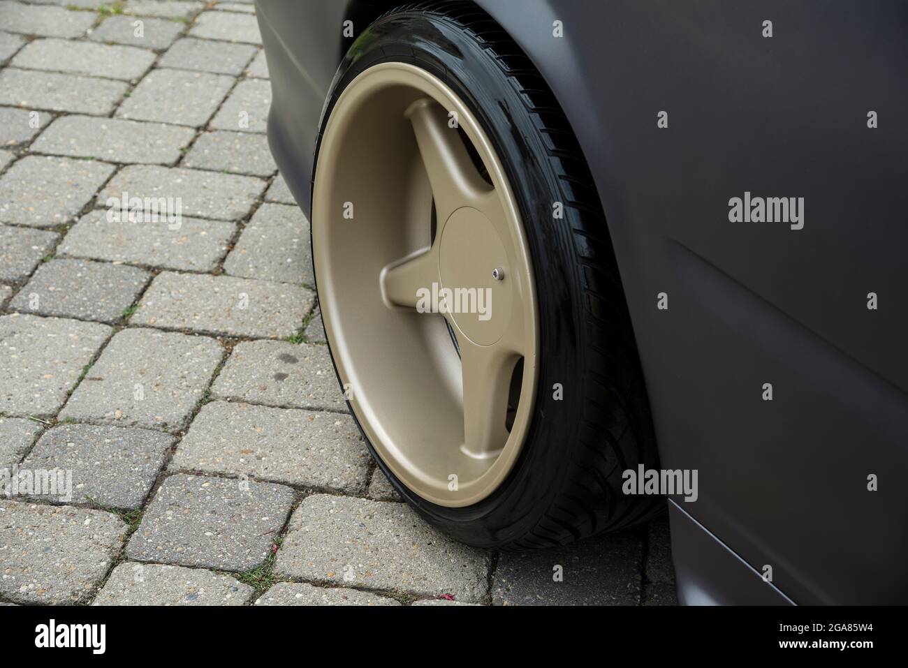 Modern car wheel with a light alloy disc. Low chassis Stock Photo - Alamy