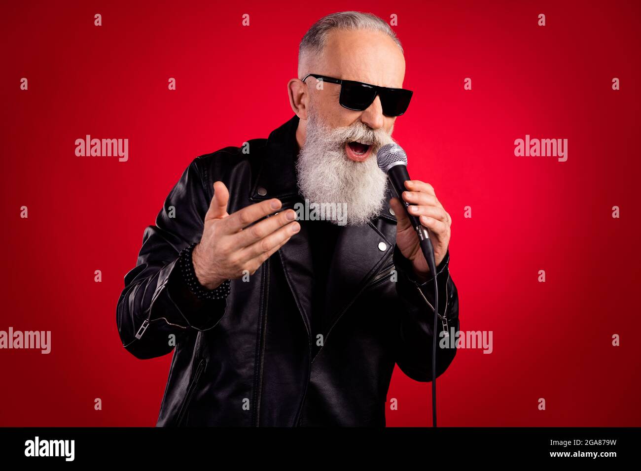 Portrait of attractive talented grey-haired man singing hit single ...