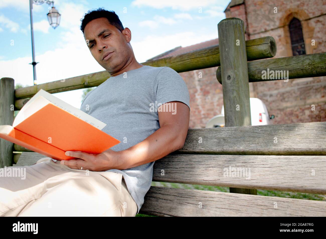 Hispanic man reading book outside hi-res stock photography and images ...